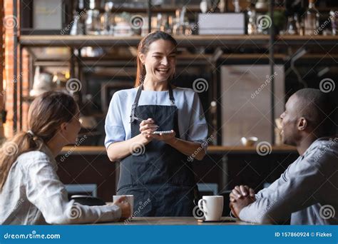 Attractive Waitress Laughing At African American Man Joke Serving