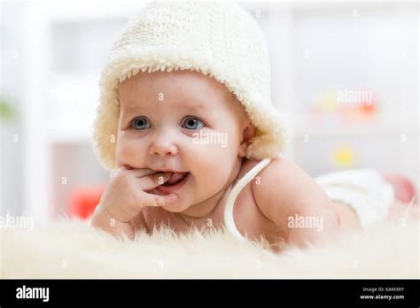 Cute Baby Girl Weared In White Hat Sucking Her Fingers Stock Photo Alamy
