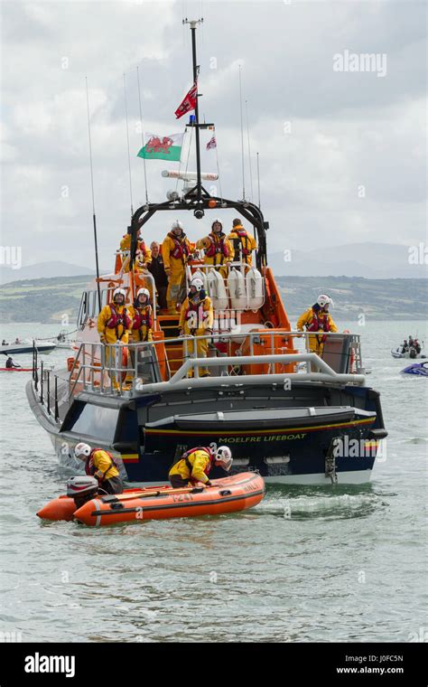 Rnli Lifeboat With A Full Crew Launching A Rigid Inflateable Boat Or