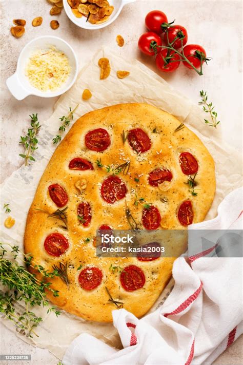 밝은 갈색 배경에 체리 토마토 파마산 로즈마리와 함께 이탈리아 전통 포카치아 빵 베이킹 위쪽 보기 건강한 식생활에 대한 스톡