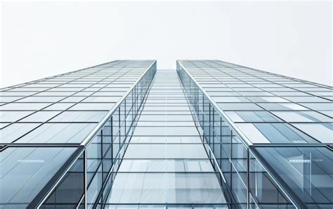 A Tall Building With A Glass Facade And A Sky Background Premium Ai