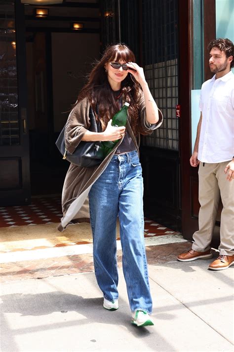 Dakota Johnsons Off Duty Look Mixes Dad Sneakers With A Slouchy Gucci Bag