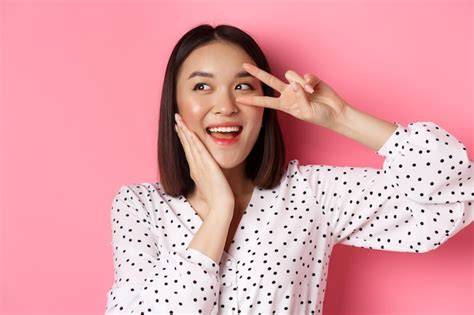 Premium Photo Portrait Of Beautiful Young Woman Against Pink Background