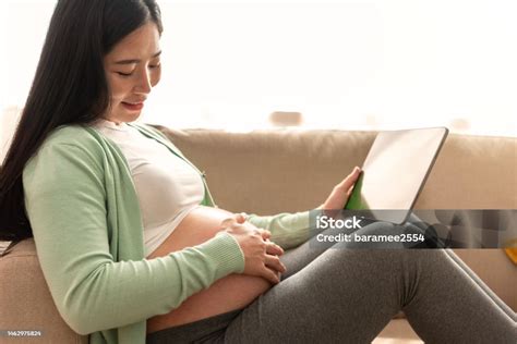 Young Asian Pregnant Woman Hands Fondle On Belly And Holding Green Chroma Key Screen On Tablet ...