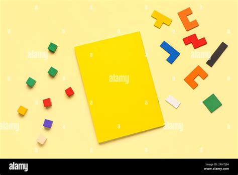 Notebook With Cubes And Blocks On Yellow Background Logic Concept