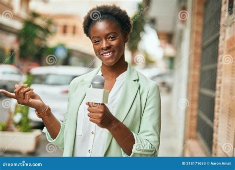 Young African American Reporter Woman Using Microphone At The City