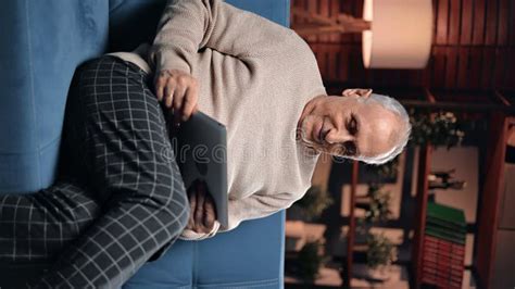 Vertical Video Pov Old Man Using Modern Tablet At Home In Evening