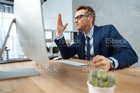 사무실에서 컴퓨터 모니터와 함께 테이블에 손으로 몸짓 안경에 염증된 사업가 모던 양식에 대한 스톡 사진 및 기타 이미지 모던