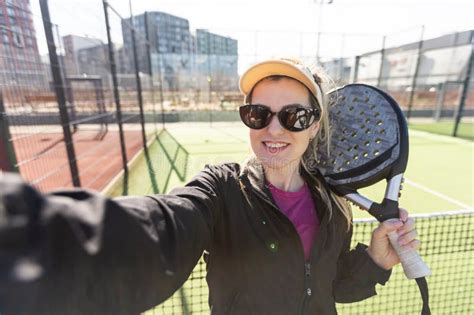 Sporty European Woman Padel Tennis Player Trains On The Outdoor Court