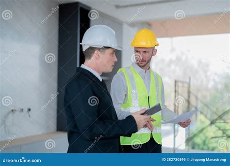 Multi Ethnic Engineer Brainstorming And Measuring For Cost Estimating