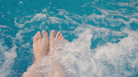 Close Up Of Feet Of A Woman With Pink Nail Polish On Toenails Stock