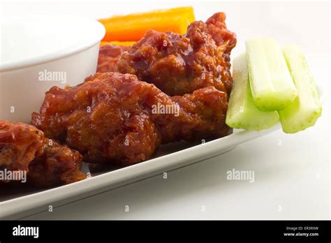 Spicy Bbq Buffalo Chicken Wings With Carrot Sticks And Celery And