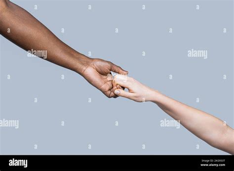 Woman And African Woman Hand Helping Hand Rescue Multiathnic People