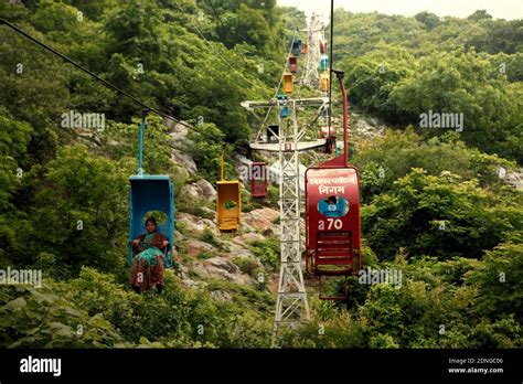 Visitors Making A Journey Using One Seated Wagons On A Ropeway System
