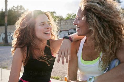 Sporty Daughter And Mother Laughing Outside By Stocksy Contributor