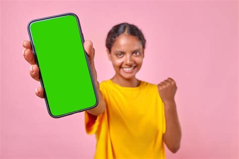 Premium Photo Young Cheerful Indian Woman Holding Smartphone And