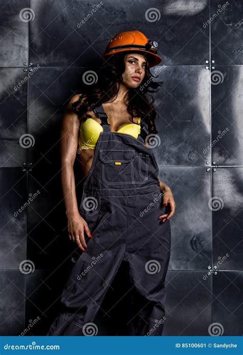 Female Miner Worker With Pickaxe In Coveralls Over His Naked Body Sitting On The Floor On