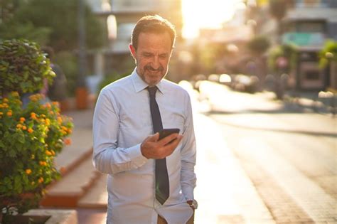 거리에서 웃고 스마트 폰을 사용하여 중년 잘 생긴 사업가 거리에 대한 스톡 사진 및 기타 이미지 거리 걷기 경영자 Istock