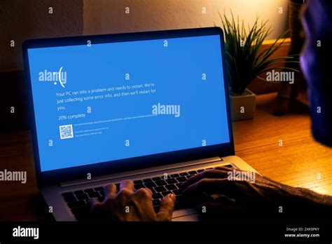 Man With Laptop Showing Blue Screen Of Death Or Bsod On The Monitor