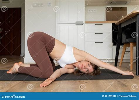 Portrait Of Young Slim Woman Doing Exercise Extended Puppy Pose