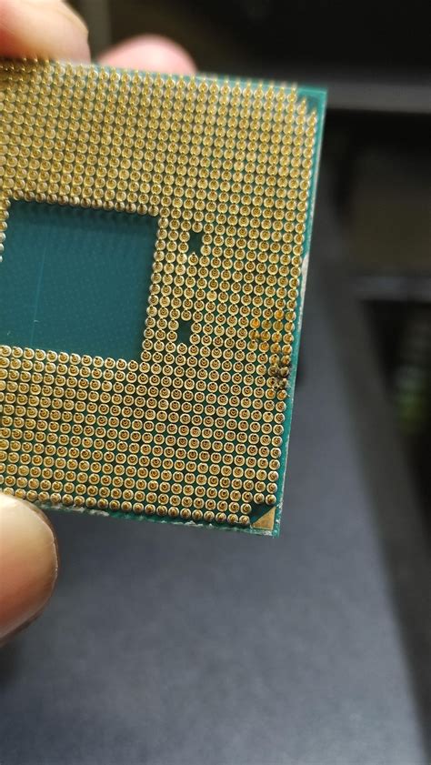 my cpu light is on pulled processor out and 2 pins are black help r