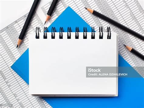 테이블에는 보고서 파란색 노트북 검은 색 연필 및 텍스트를 삽입 할 수있는 장소가있는 노트북이 있습니다 템플렛 비즈니스 컨셉 0