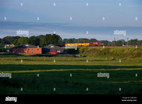 Db Schenker Class 66 Diesel Locomotive In Ews Livery Hauling Freight A Train Carrying Materials