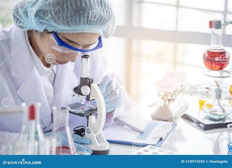 Female Scientist Look At Microscope Science Test Tube Analyse