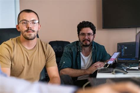 Collaborative Minds A Team Of Programmers Tackling Challenges Together In The Office Stock