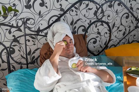 A Man And Home Spa Care At Home Takes Care Of Himself And Smears His Face With Cream Does A ...
