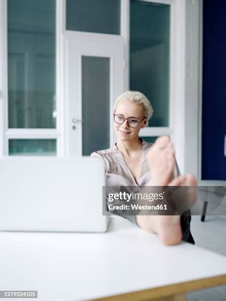 Business Woman Feet On Desk Photos And Premium High Res Pictures