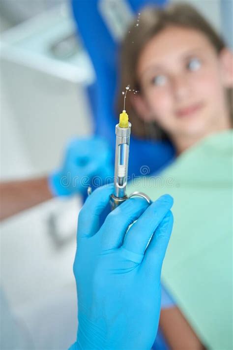Teenage Patient Staring At Stomatologist Before Local Anesthetic