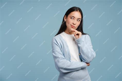 Premium Photo Pensive Attractive Asian Woman Looking Away And