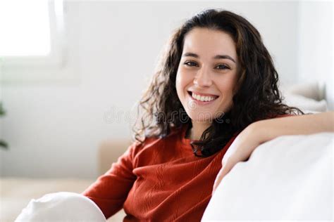 Portrait Of A Beautiful Young Happy Woman Relaxing Sitting In The Couch