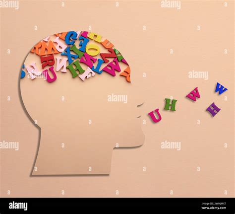 Silhouette Of A Human Head With Letters In The Brain On A Beige