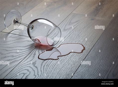 Wooden Floor With Overturned Glass Of Red Wine Spilled Wine On A