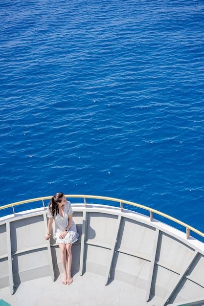 Premium Photo A Woman Sitting On The Viewing Deck Near The Water Photo