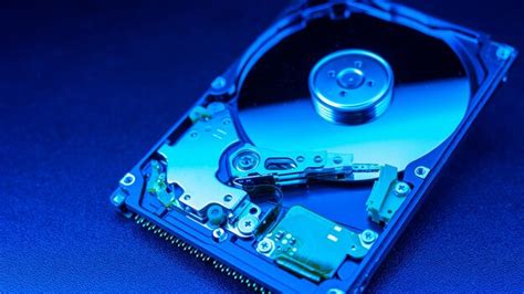 Premium Photo An Open Hard Disk Disassembled Hdd Of A Computer Or Laptop Lies On A Blue