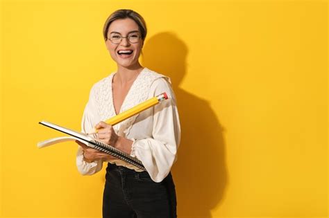 Premium Photo Cheerful Woman Wearing Glasses Holding Big Pencil And