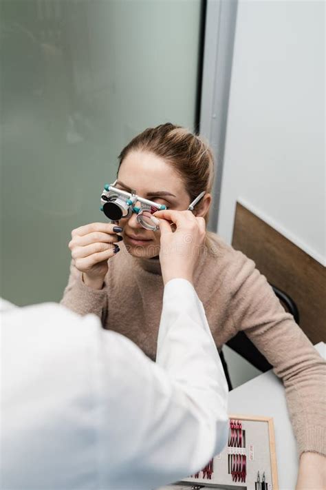 Ophthalmologist Selects Lenses For Trial Frame Of Glasses Examination