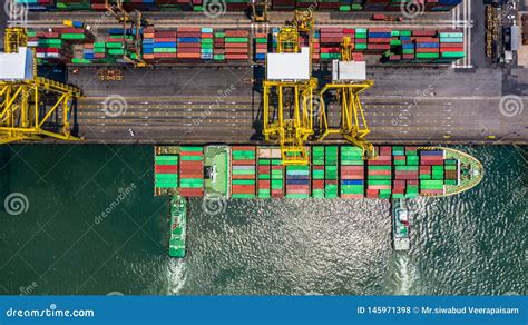 container ship loading and unloading in deep sea port aerial top view
