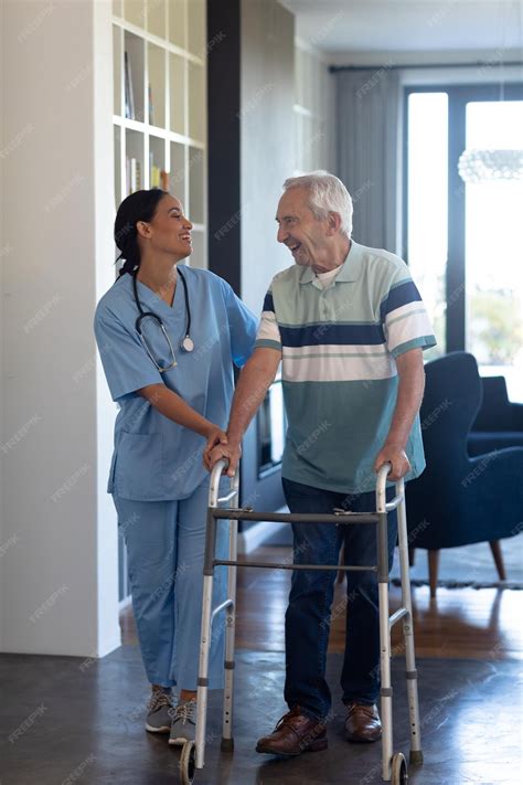 Premium Photo Biracial Female Physiotherapist Talking And Assisting