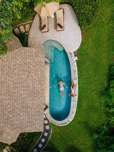Couple European Man And Asian Woman In Infinity Pool In Thailand