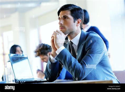 Portrait Of A Pensive Businessman Sitting At The Table In Office Stock