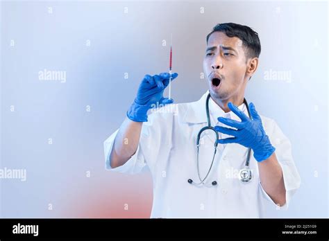 Asian Nerd Scientist Standing And Holding A Syringe With Blurred Background Stock Photo Alamy