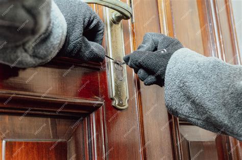 Premium Photo Hands Of Thief Picking The Lock