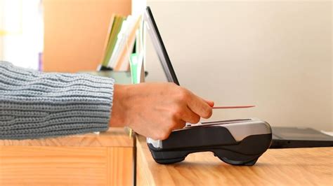 Premium Photo A Person Using A Printer To Insert A Credit Card