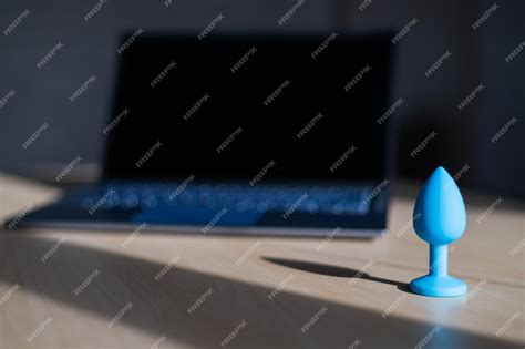 Premium Photo Blue Latex Anal Plug The Laptop On The Table The Concept Of Virtual Sex On The