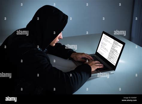 Hacker Stealing Information From Laptop Stock Photo Alamy