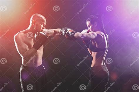 Shirtless Woman Exercising With Trainer At Boxing And Self Defen Stock